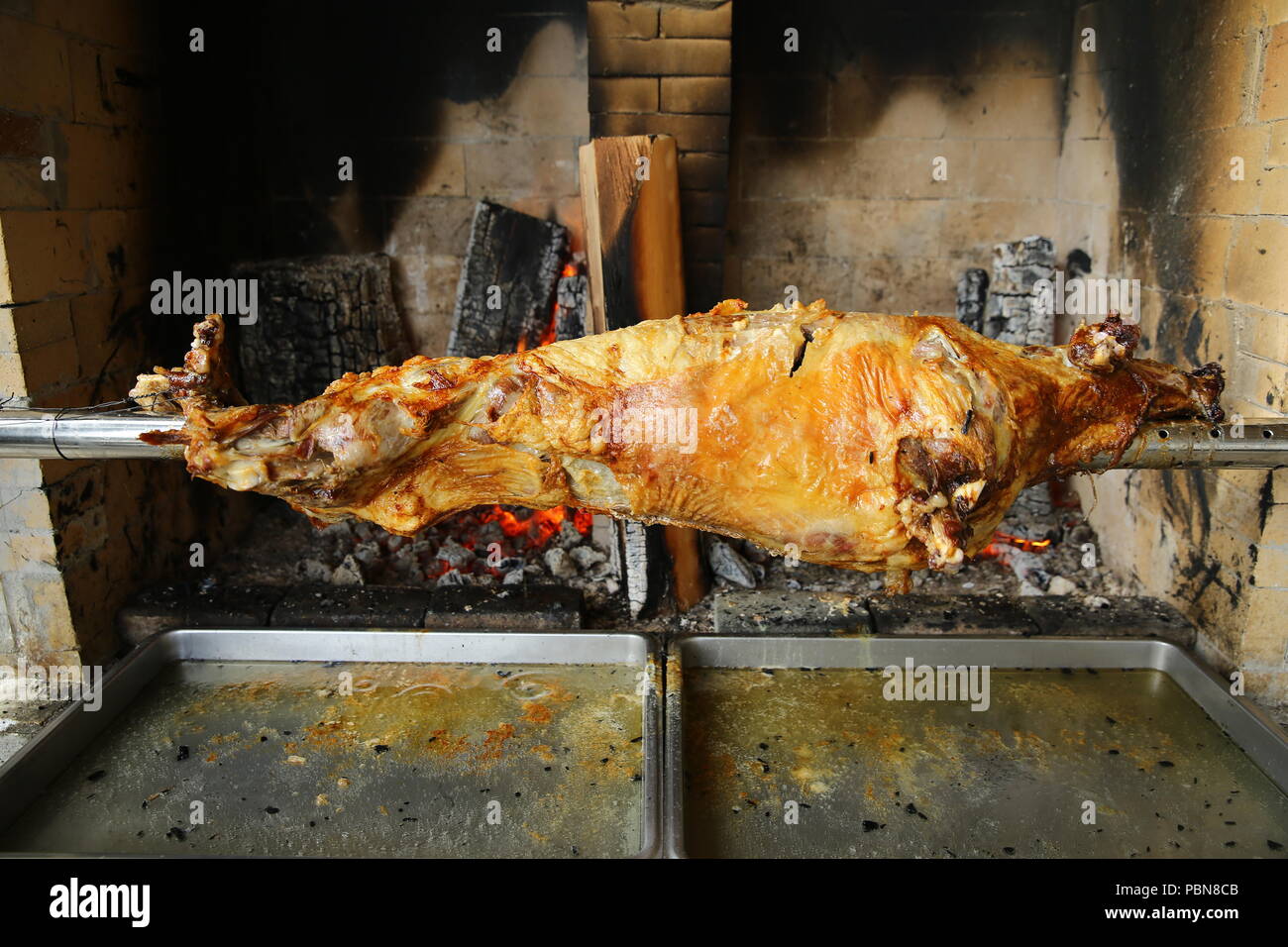 Roast lamb on a spit on fire Stock Photo - Alamy