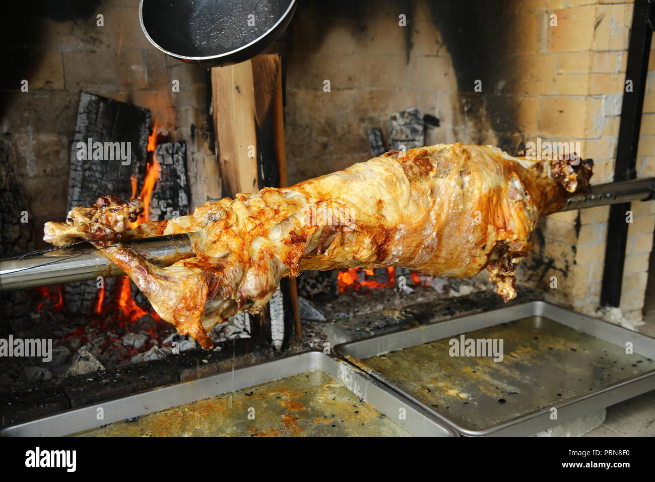 Roast lamb on a spit on fire Stock Photo - Alamy