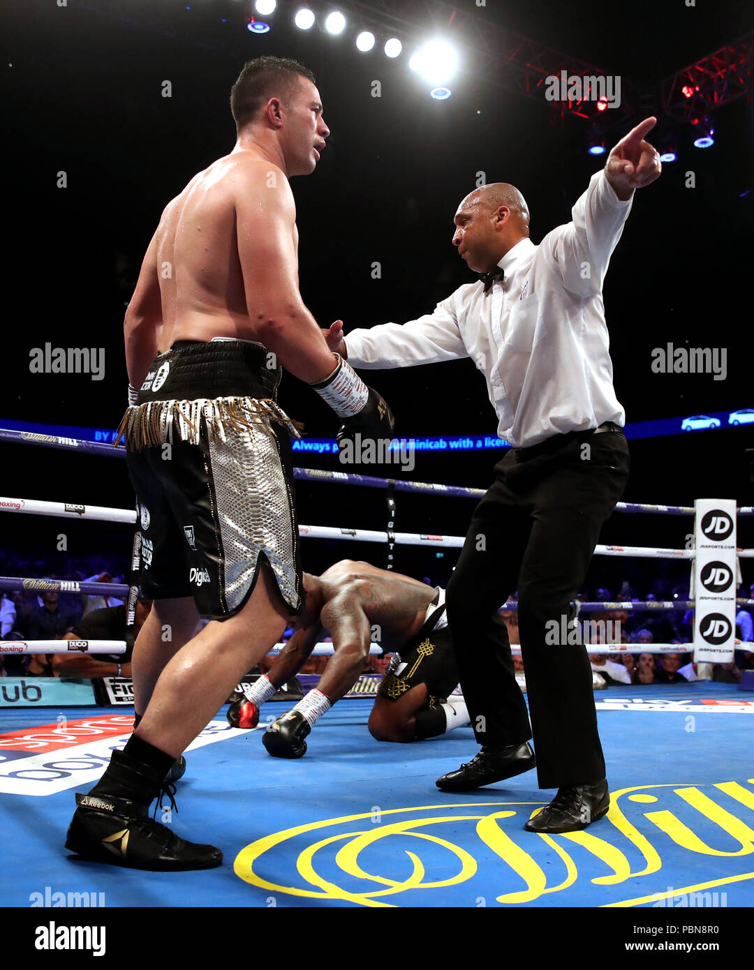 Joseph Parker (left) stands over Dillian Whyte during their WBC Silver ...