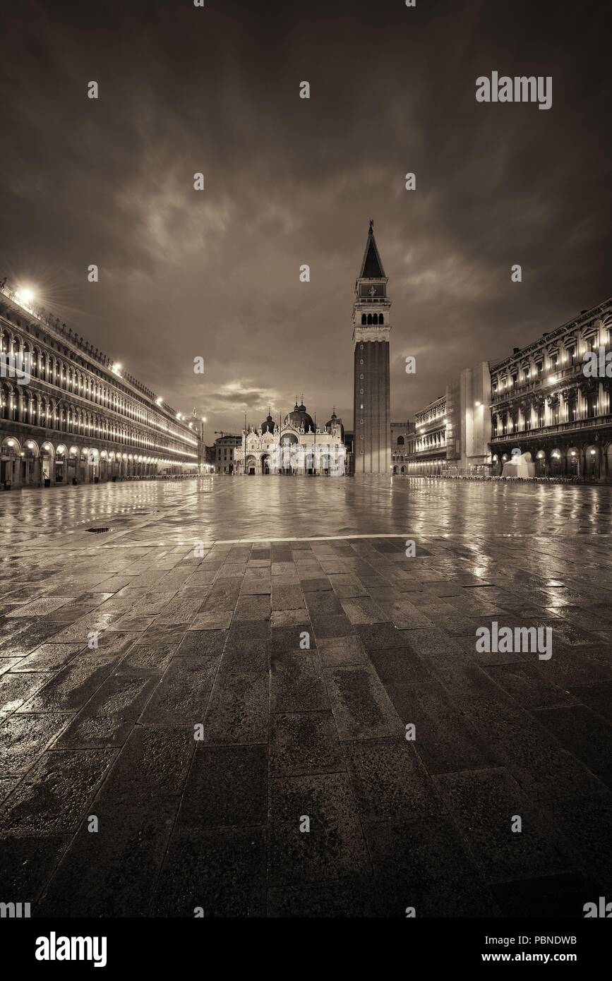 Bell tower and historical buildings at night at Piazza San Marco in ...
