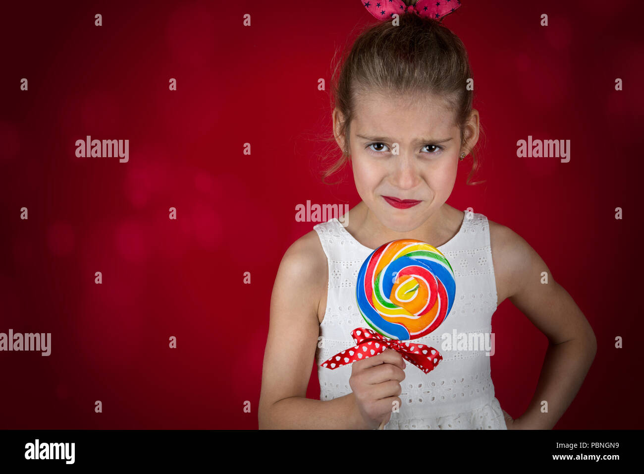 No sugar. Portrait of a pretty little caucasian girl with a big round ...