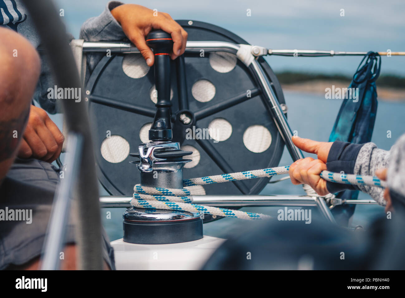 Woman pulling rigging rope for sail on sailboat Stock Photo - Alamy