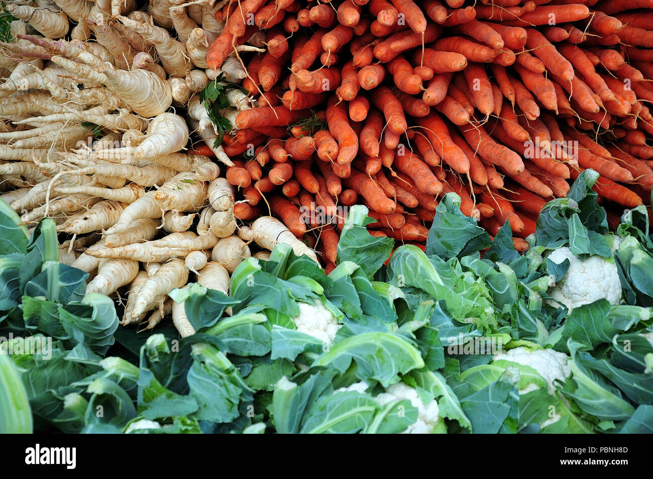 pile of vegetables at market stall, including carrots, cauliflower and ...