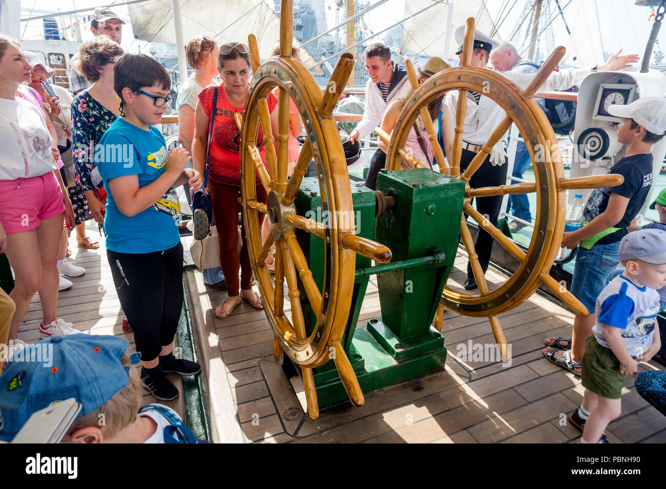 Russia, Vladivostok, 07/28/2018. Many tourists around handwheel of ...