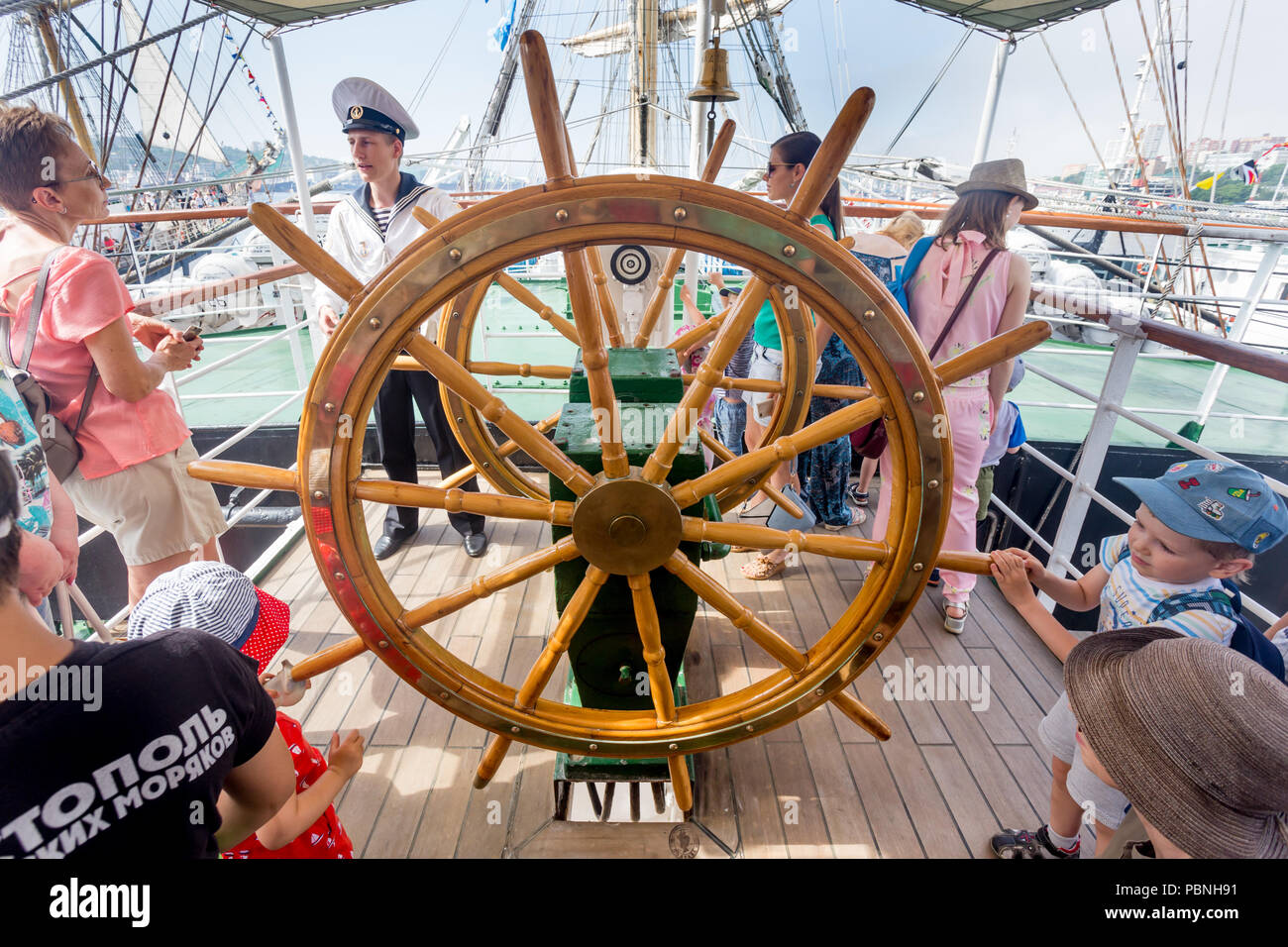 Russia, Vladivostok, 07/28/2018. Many tourists around handwheel of ...