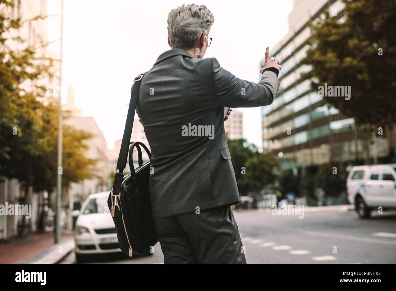 Businessman waiting for cab hi-res stock photography and images - Alamy