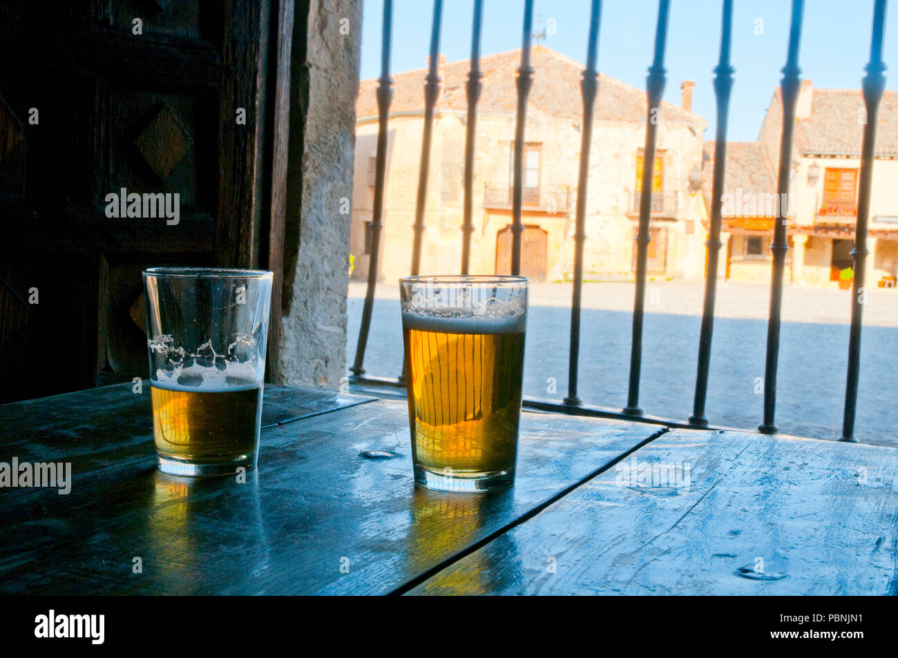 Two glasses of beer in a typical meson. Plaza Mayor, Pedraza, Segovia ...