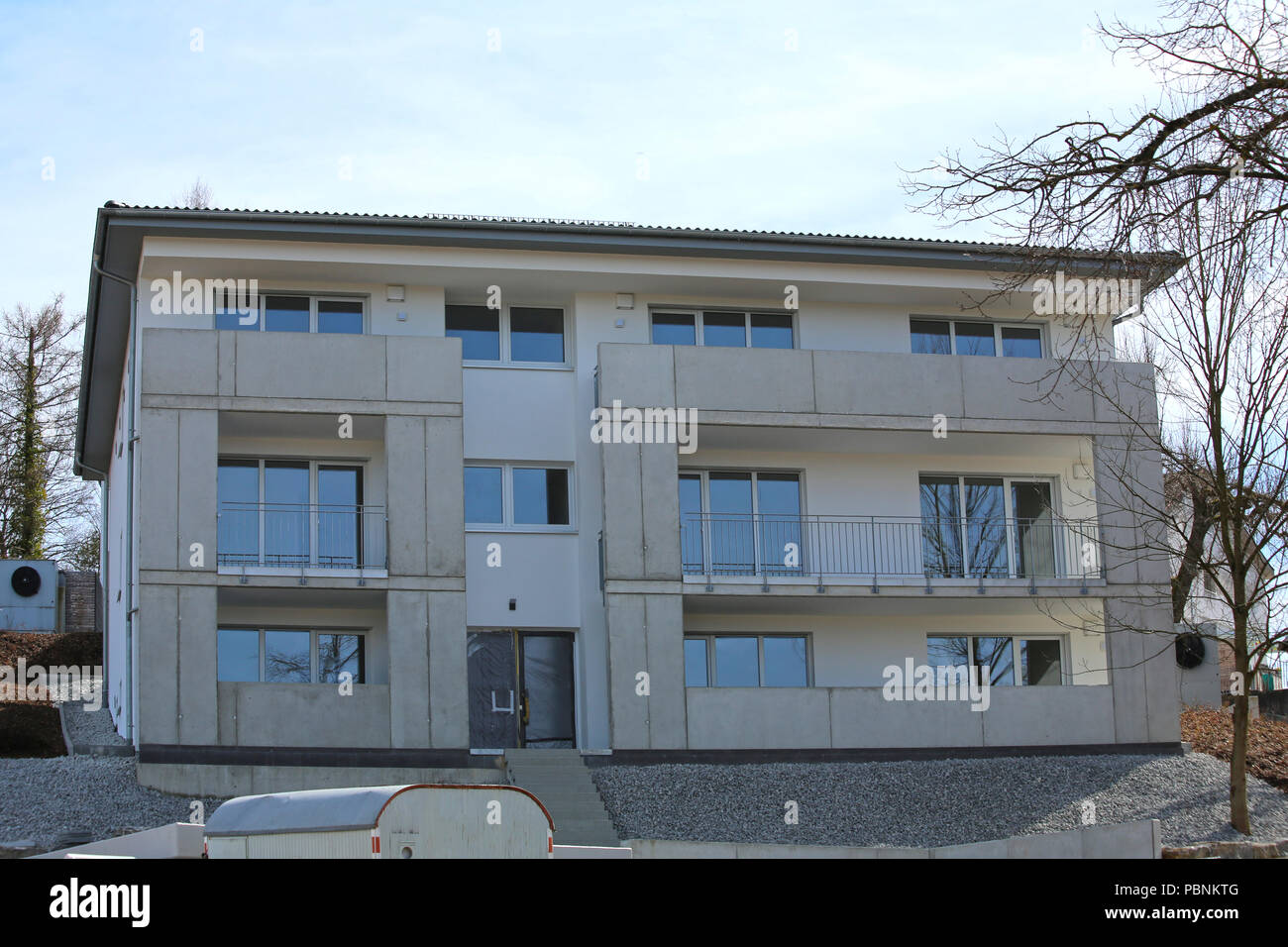 New residential building under construction, entrance door, windows and ...
