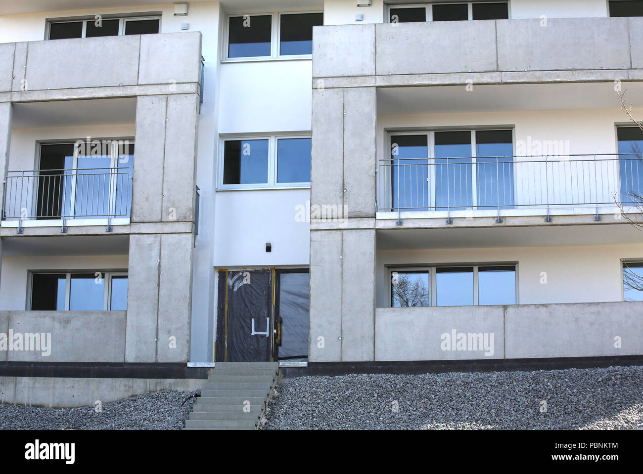 New residential building under construction, entrance door, windows and ...