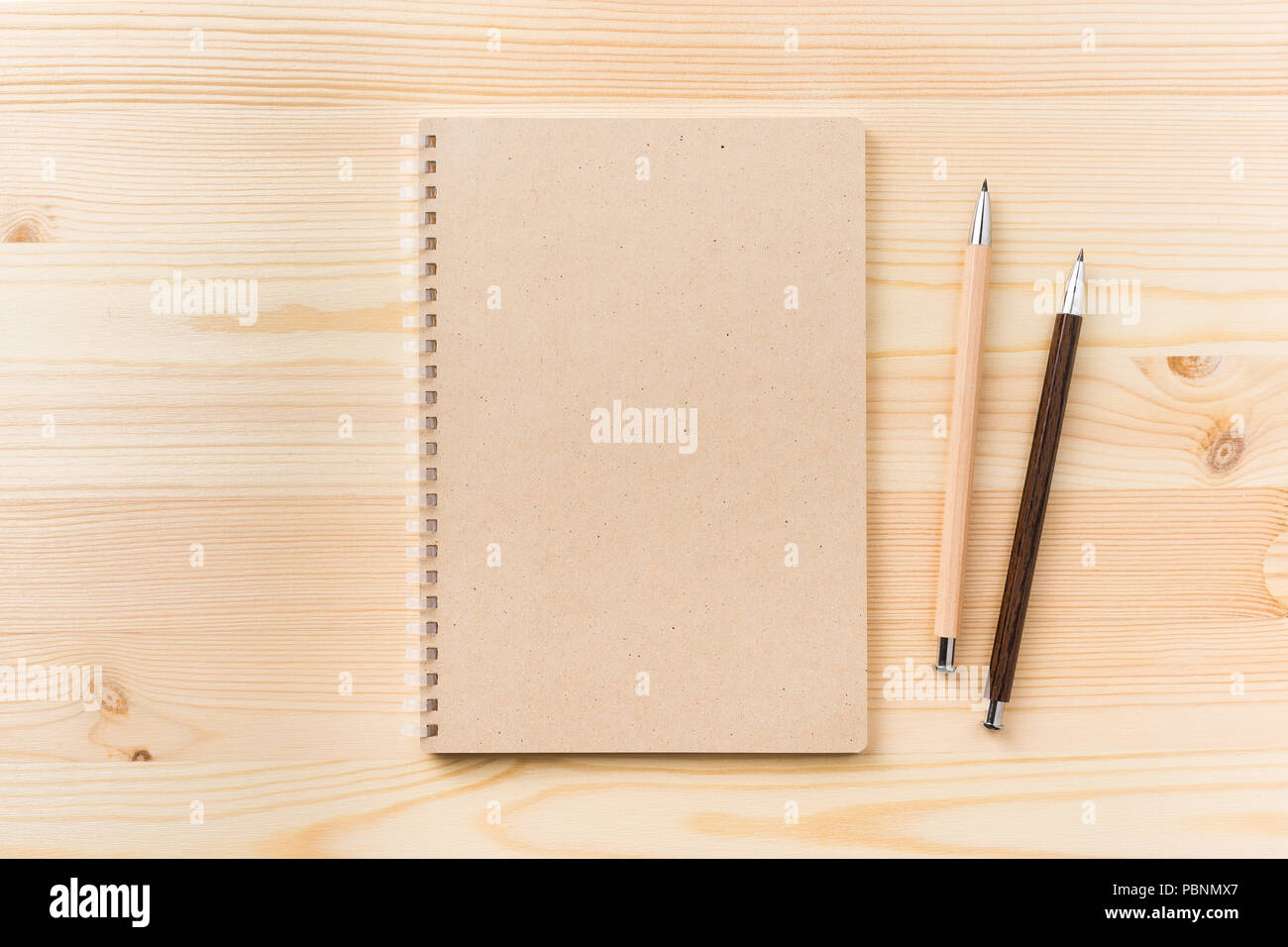 Design concept - Top view of black kraft spiral notebook and wood ...