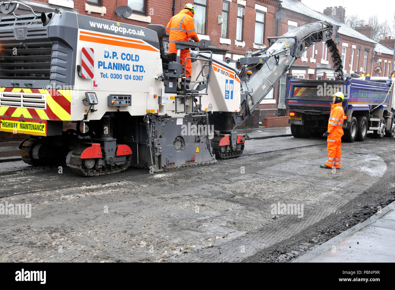 Taking up old road with cold planing prior to laying new tarmac asphalt ...