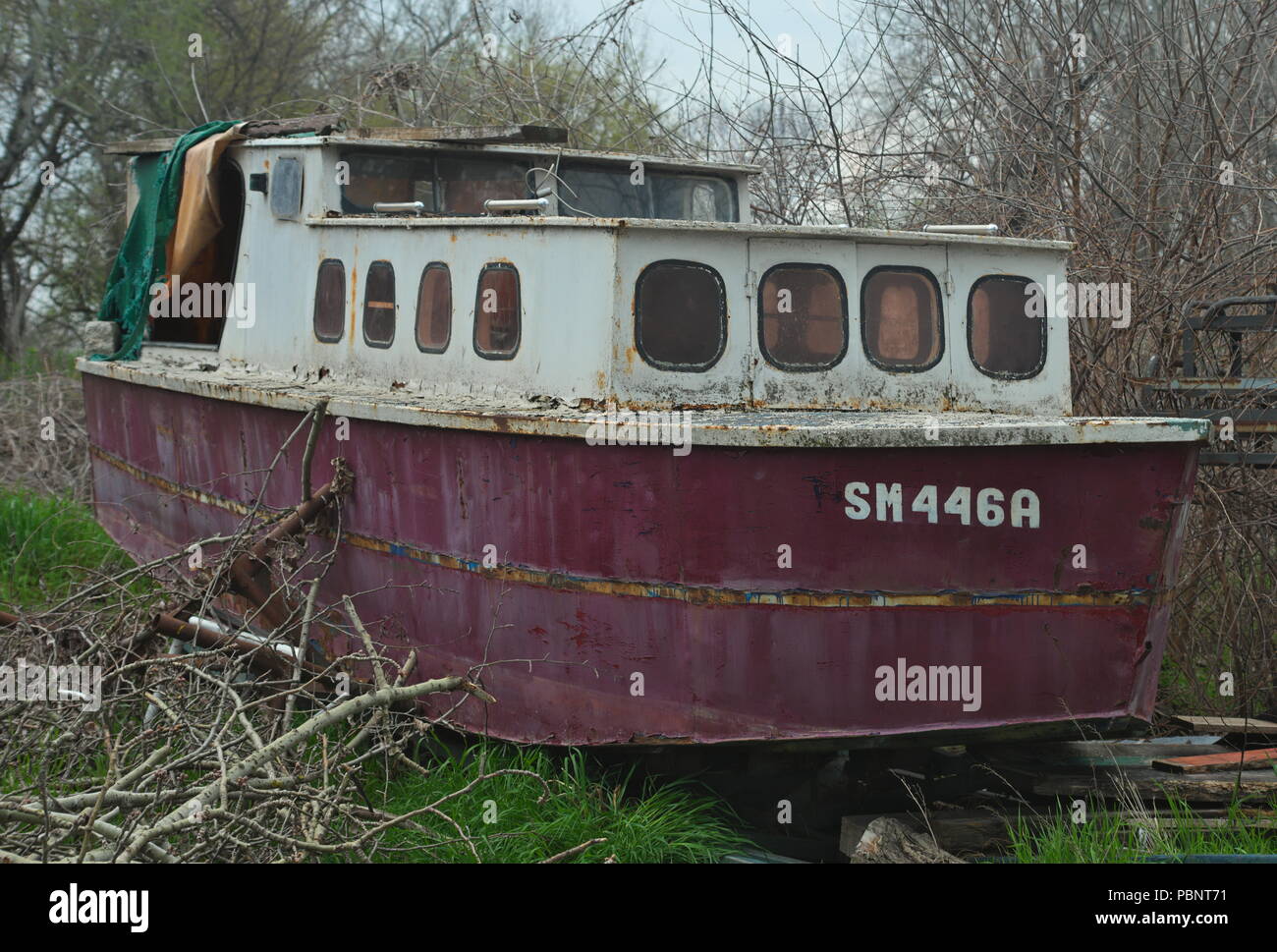 Old abandoned wrecked boat at river shore Stock Photo - Alamy