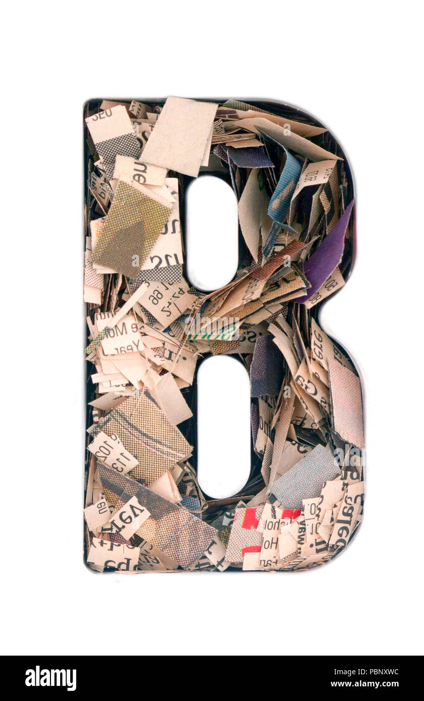 financial news newspaper cut up into confetti to make the captal letter ...