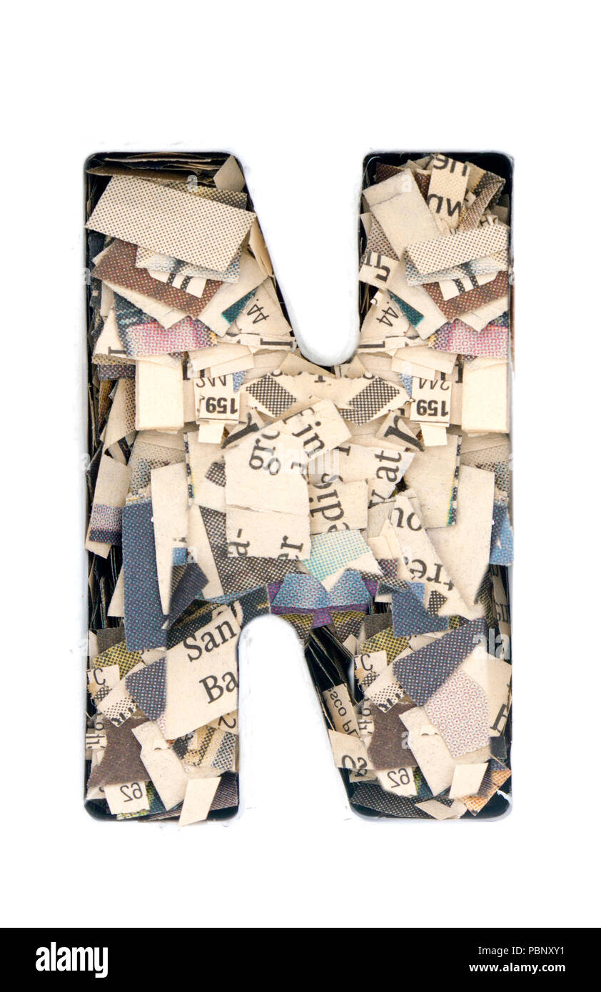 financial news newspaper cut up into confetti to make the captal letter ...