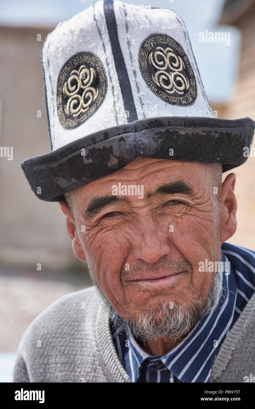 Man with kalpak hat in the bazaar, Sary Mogul, Kyrgyzstan Stock Photo ...