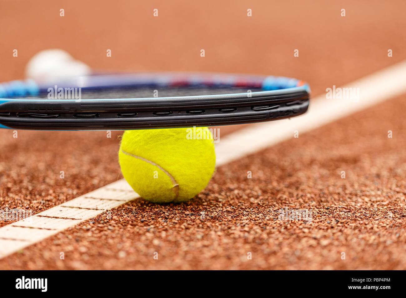 Tennis racket and ball placed on court ground Stock Photo - Alamy