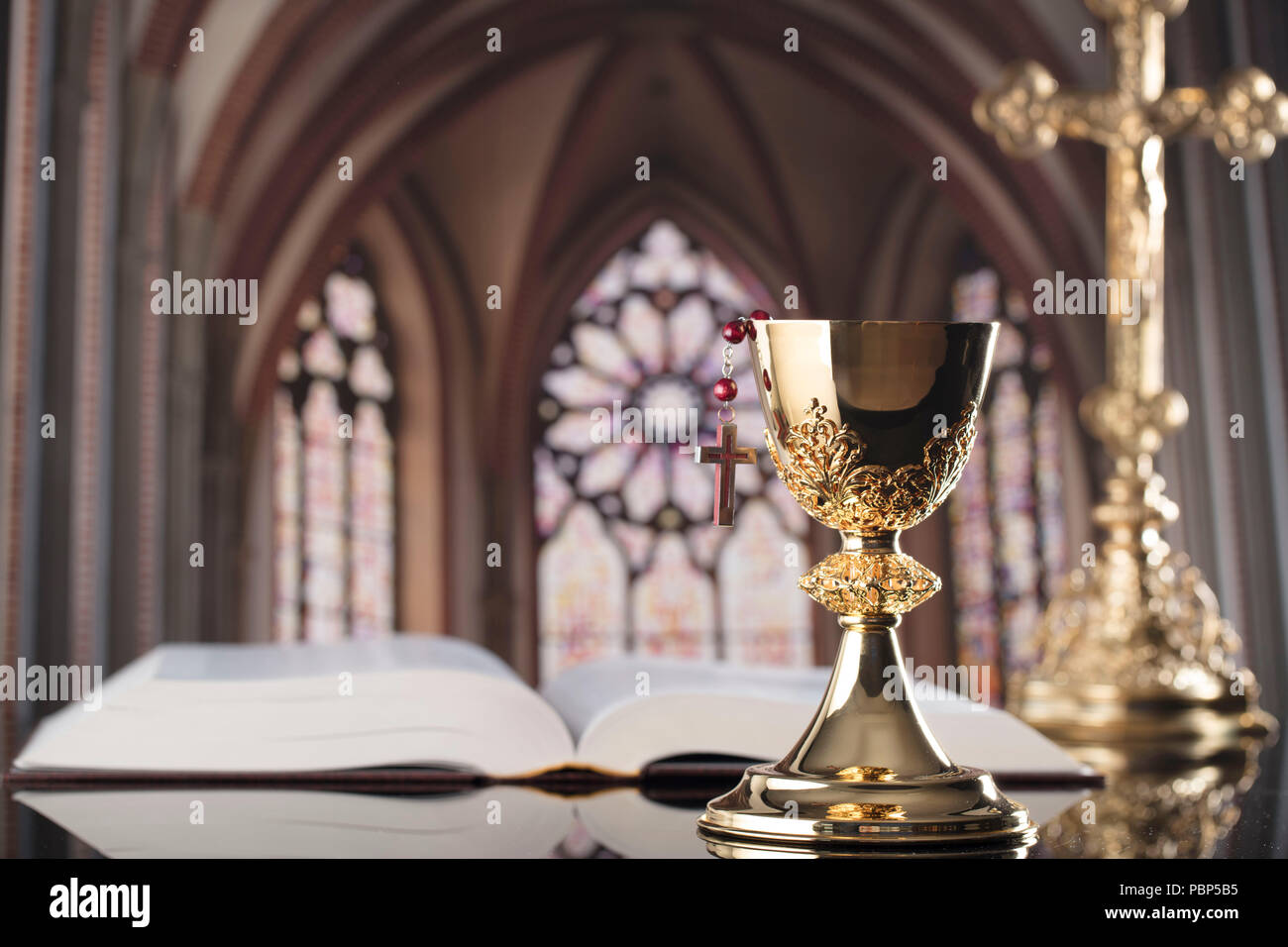 Roman Catholic Church theme. The Cross, Holy Bible, rosary and golden ...