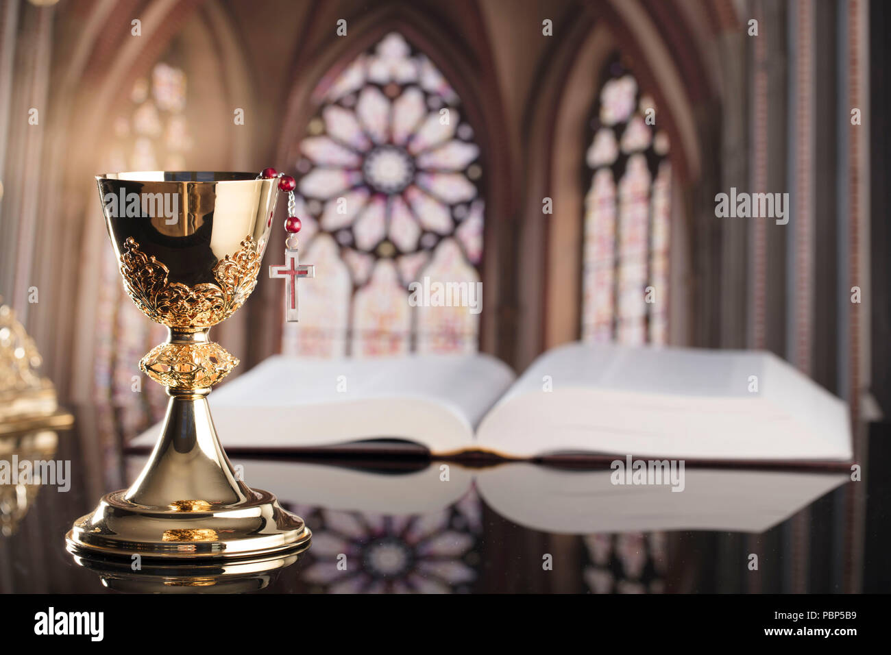 Roman Catholic Church theme. The Cross, Holy Bible, rosary and golden ...