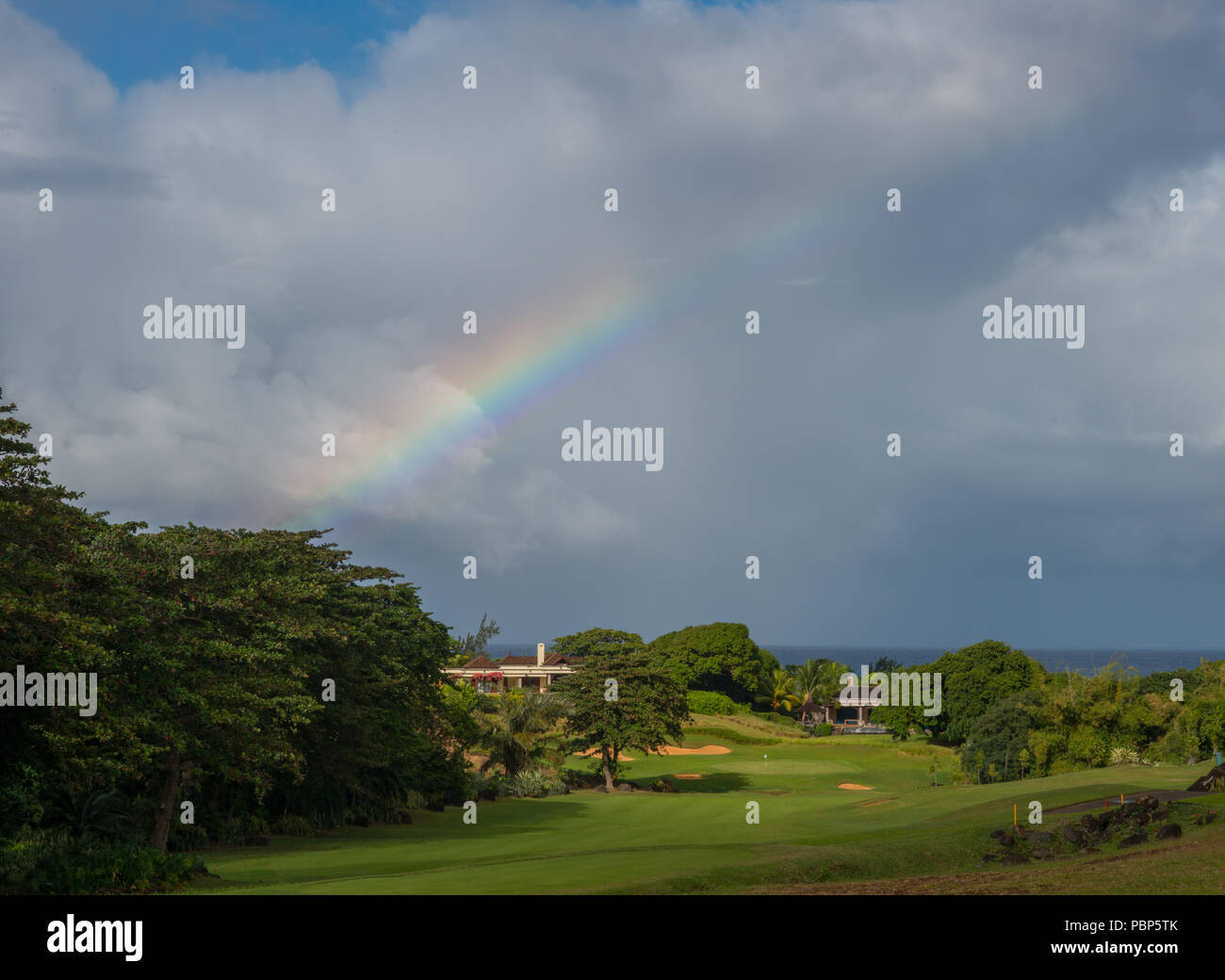Rainbow over golf course Stock Photo - Alamy