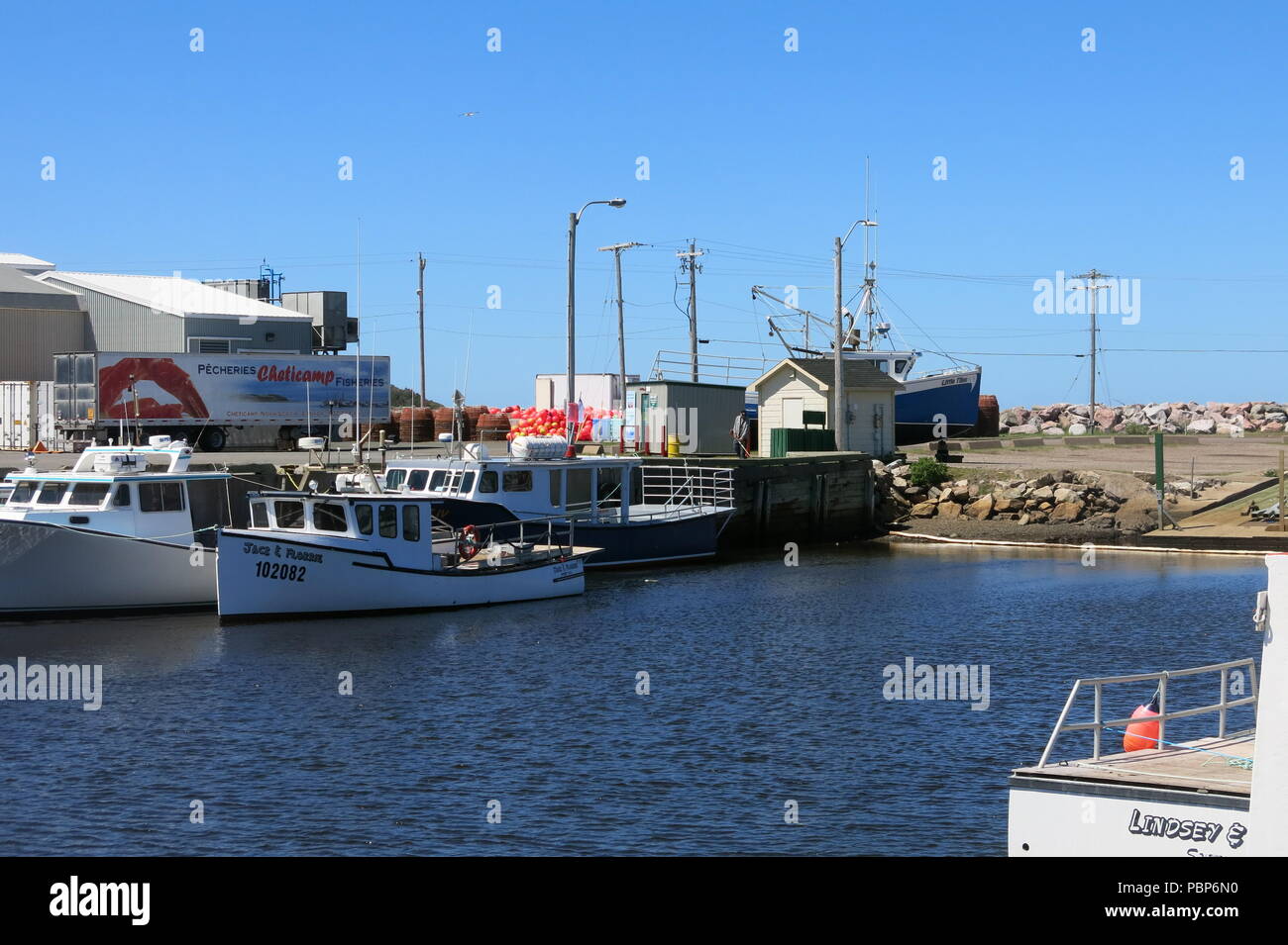 View of the fishing boats in the harbour at Cheticamp, a pretty fishing ...