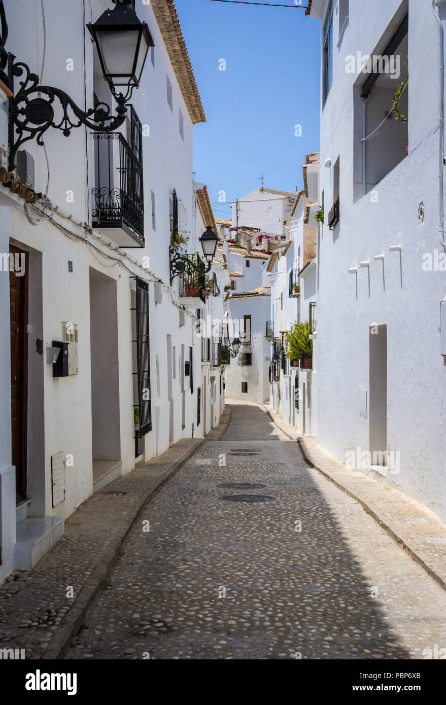 Picturesque narrow street in white village of Altea, Alicante, Spain ...