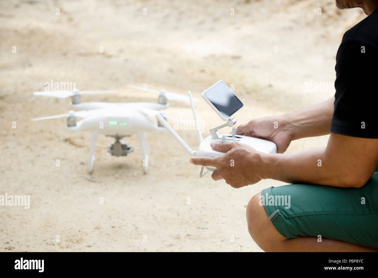 man playing drone holding remote control in hand Stock Photo - Alamy