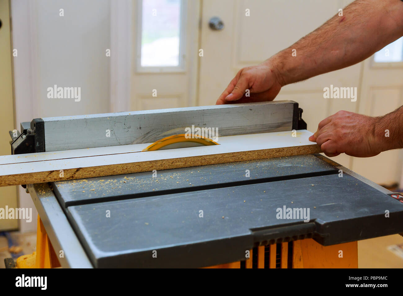 Carpenter cutting wood base trim the miter saw Stock Photo - Alamy