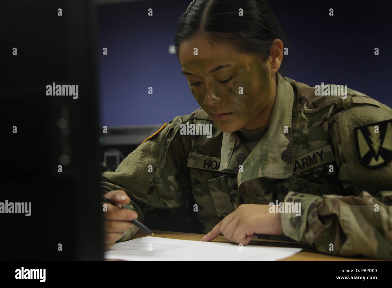 Spc. Diane Hoang, from the U.S. Army Training Center, takes the written ...