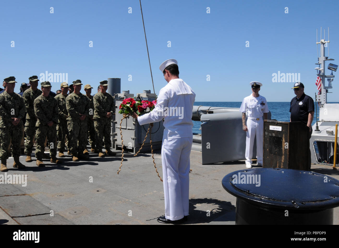 The crew aboard the USNS Grasp (T-ARS-51) and Sailors assigned to ...