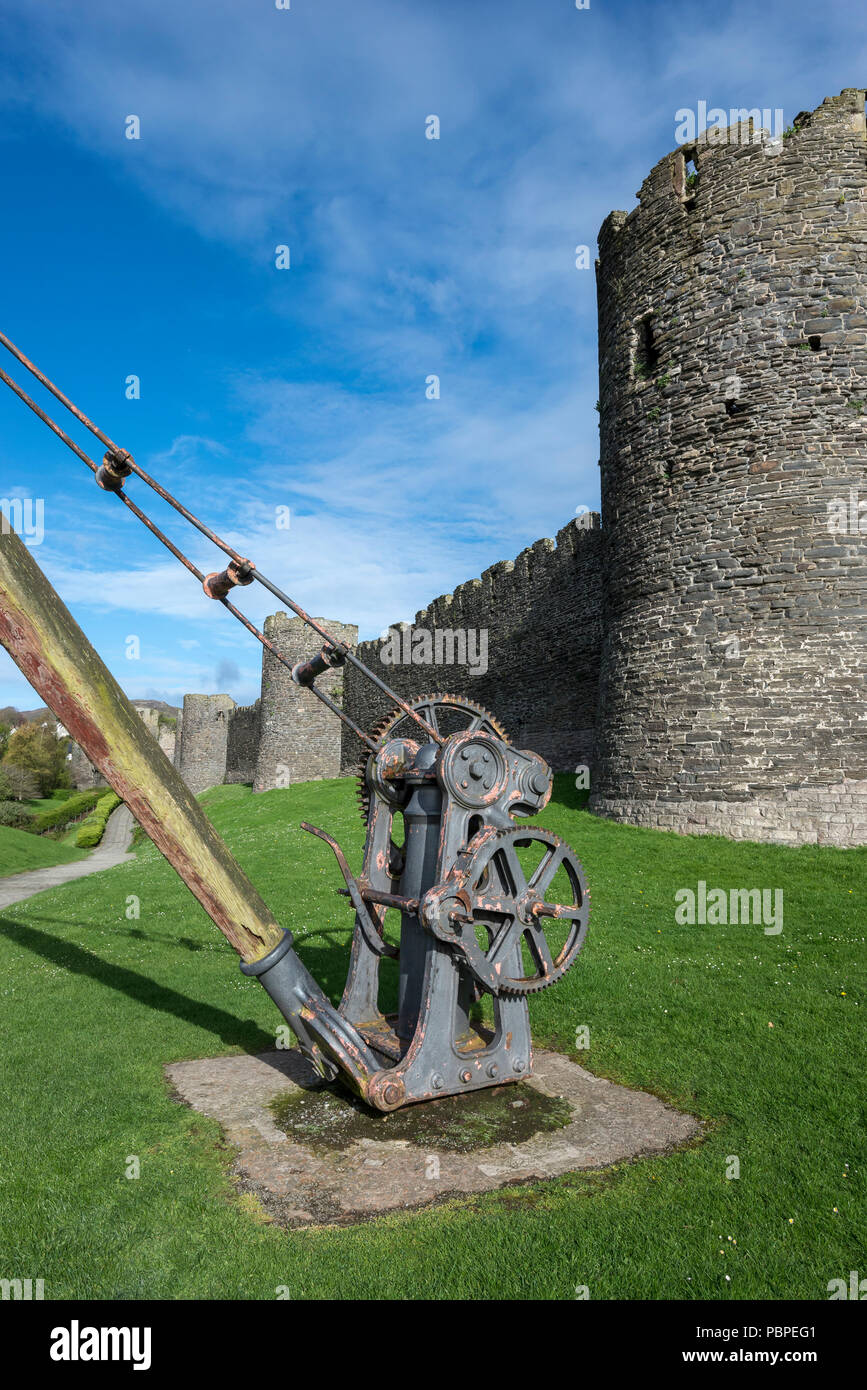 Old lifting gear beside the medieval stone walls at Conwy, North Wales ...