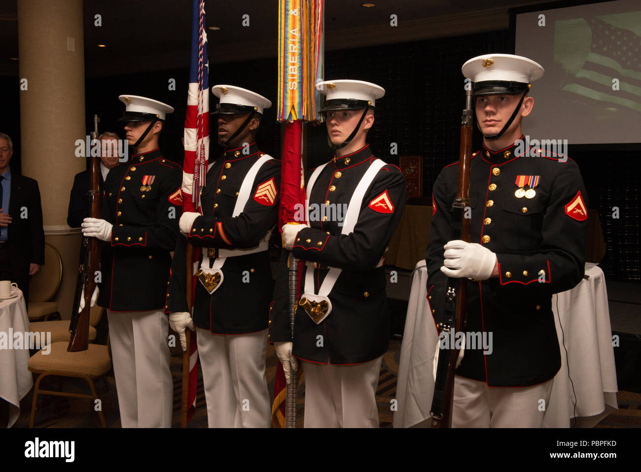 The U.S. Marine Corps Color Guard presents the National Ensign and the ...