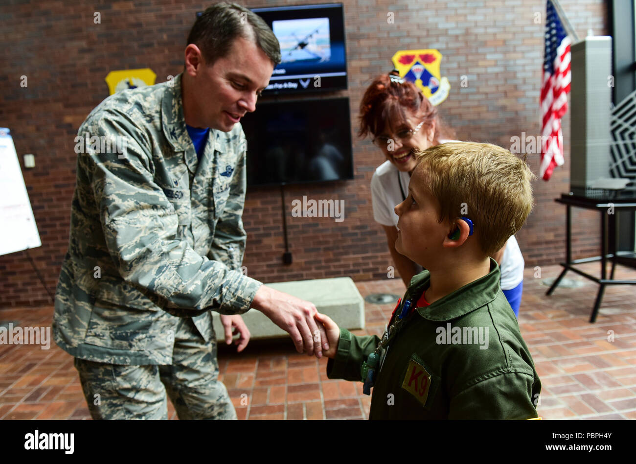 Caleb Pettit, 9, receives a commander’s coin from Col. Jeffrey Nelson ...
