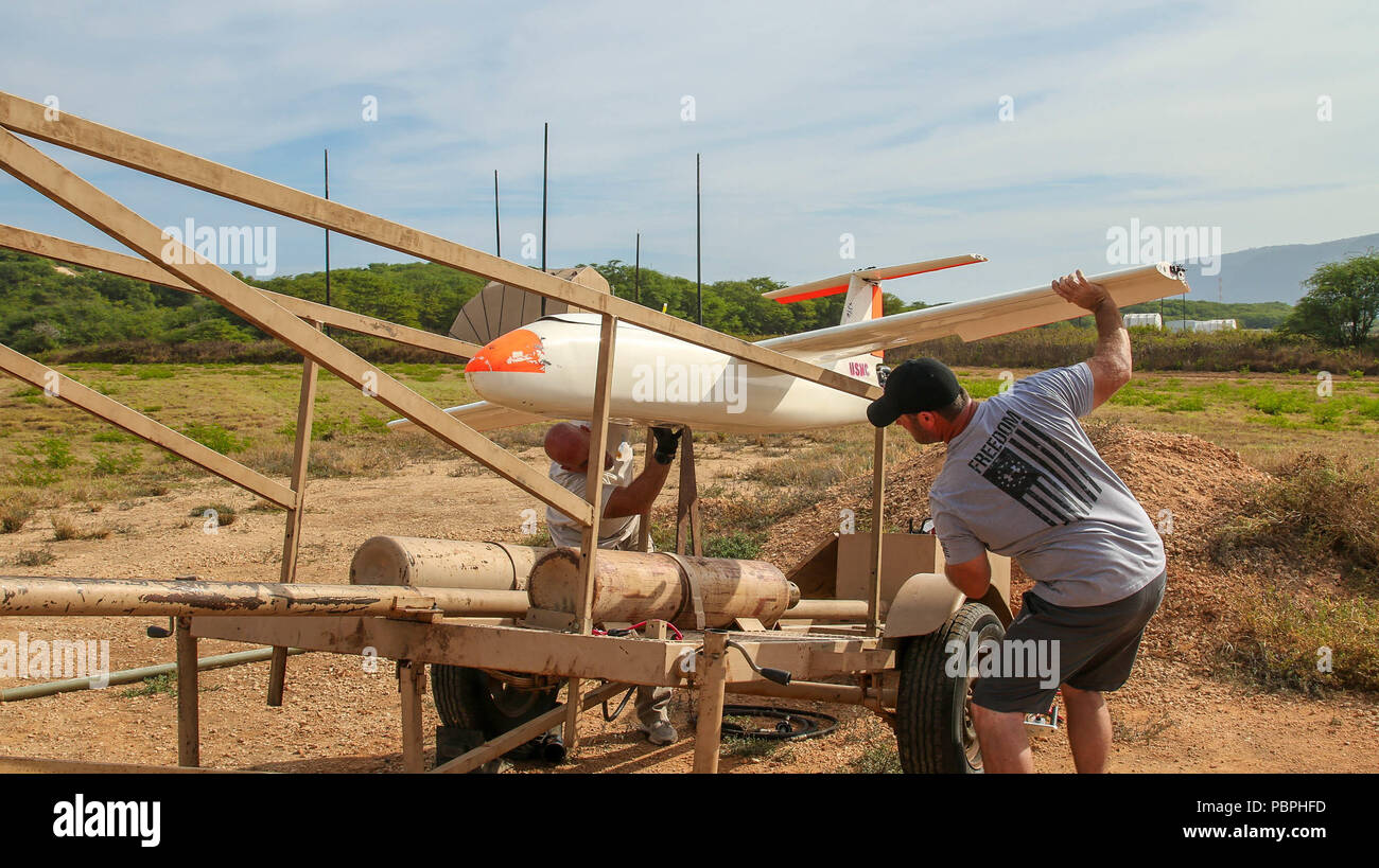 An unmanned aerial vehicle is place onto a launcher before an ...