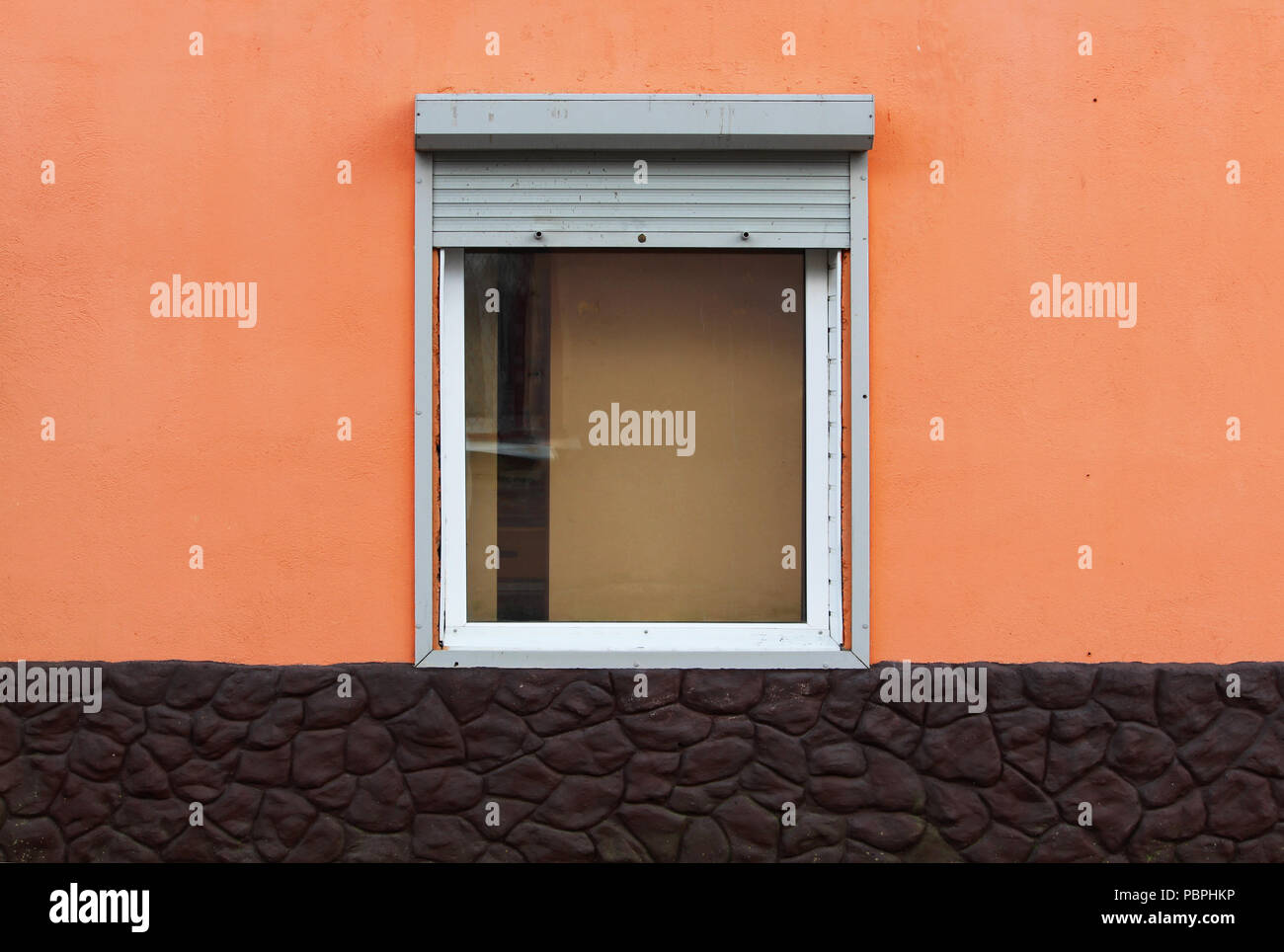 One window in the house is half closed by external shutters. bright ...