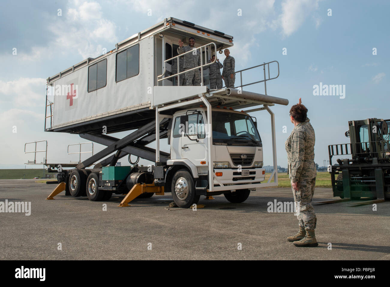 Col. Otis C. Jones, 374th Airlift Wing commander, waves from atop the ...