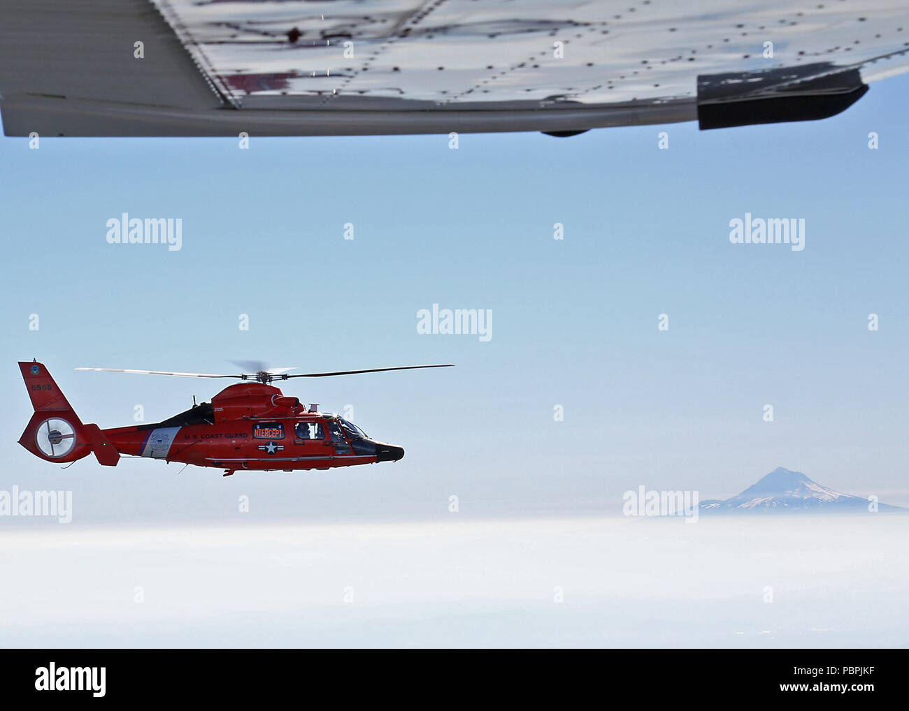 A U.S. Coast Guard HH-65 Dolphin intercepts a Civil Air Patrol Cessna ...