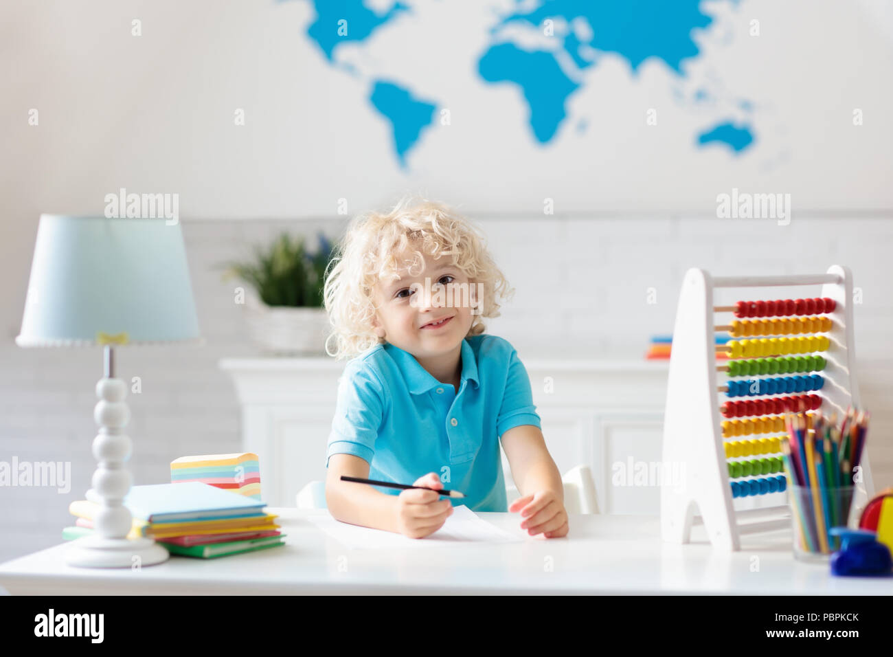 Child doing homework at home. Little boy with wooden colorful abacus ...