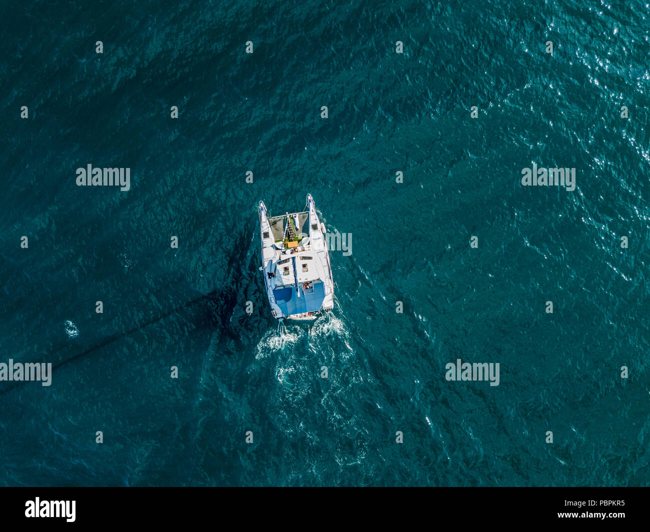 aerial top view from above of large sailing catamaran in the open sea ...