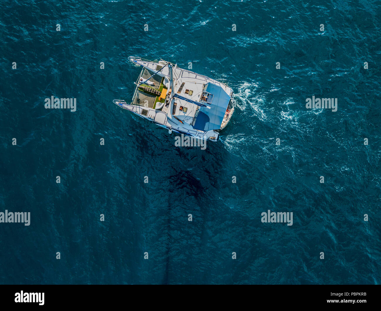 aerial top view from above of large sailing catamaran in the open sea ...
