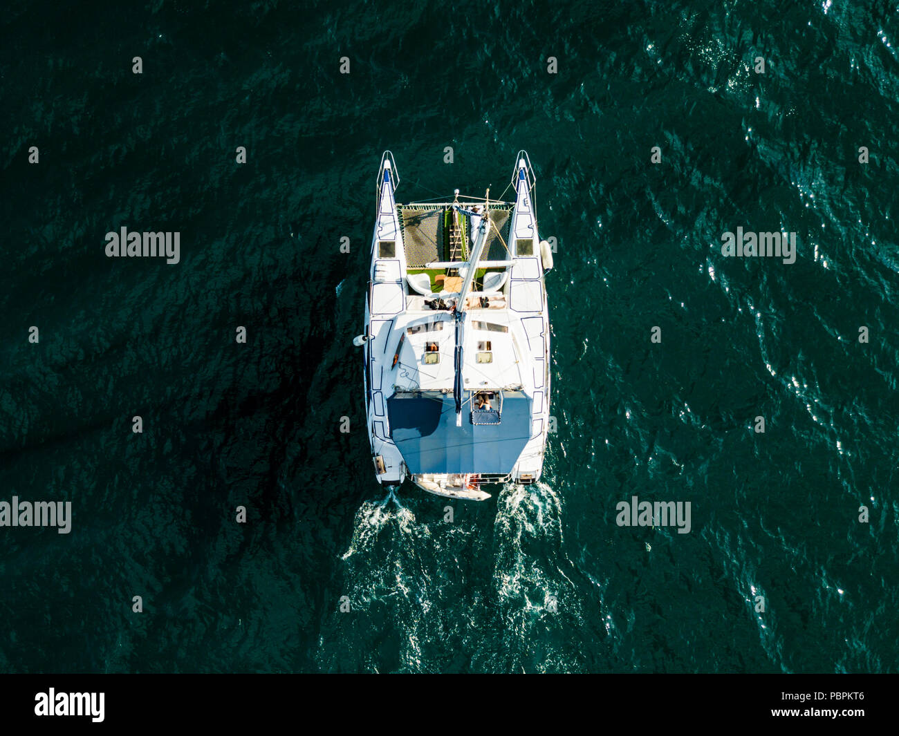 aerial top view from above of large sailing catamaran in the open sea ...
