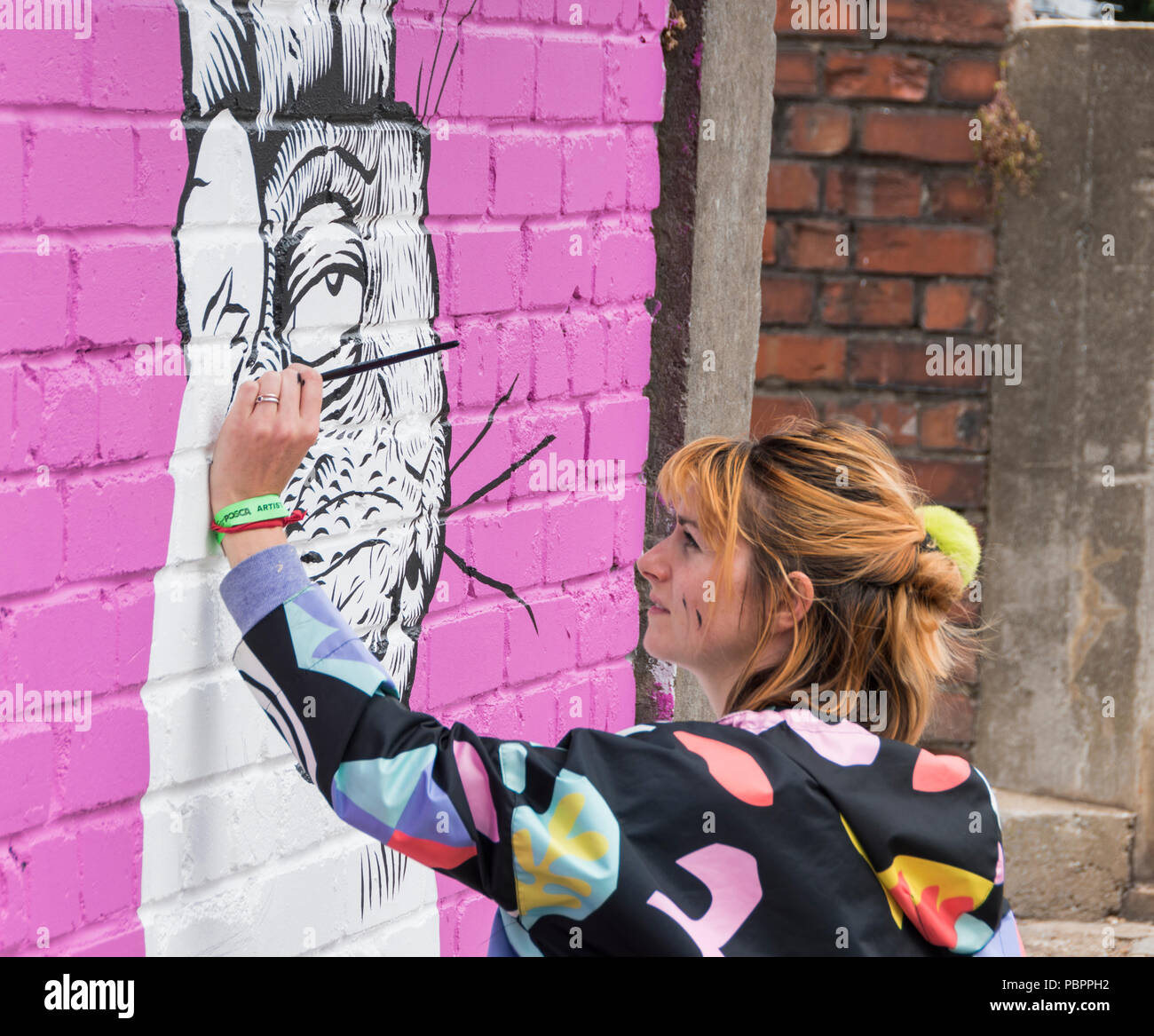 Alex Lucas of Lucas Antics working on her painted wall mural at 10th ...