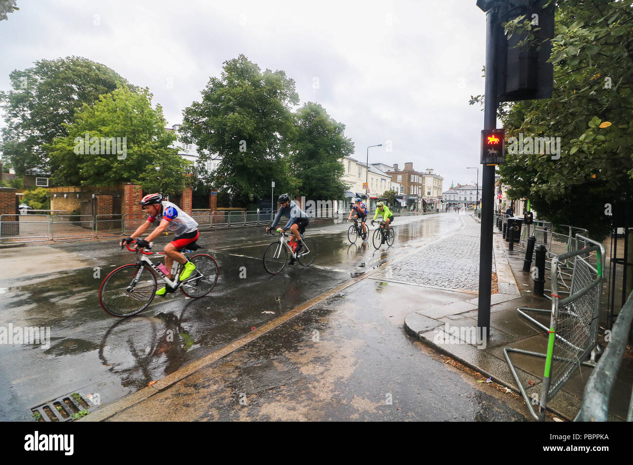 London UK. 29th July 2018. Cyclists pass through Wimbledon village in ...
