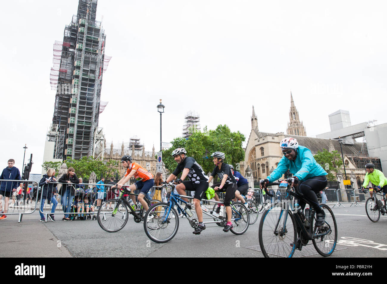 London, UK. 29th July, 2018. Riders pass through Parliament Square ...