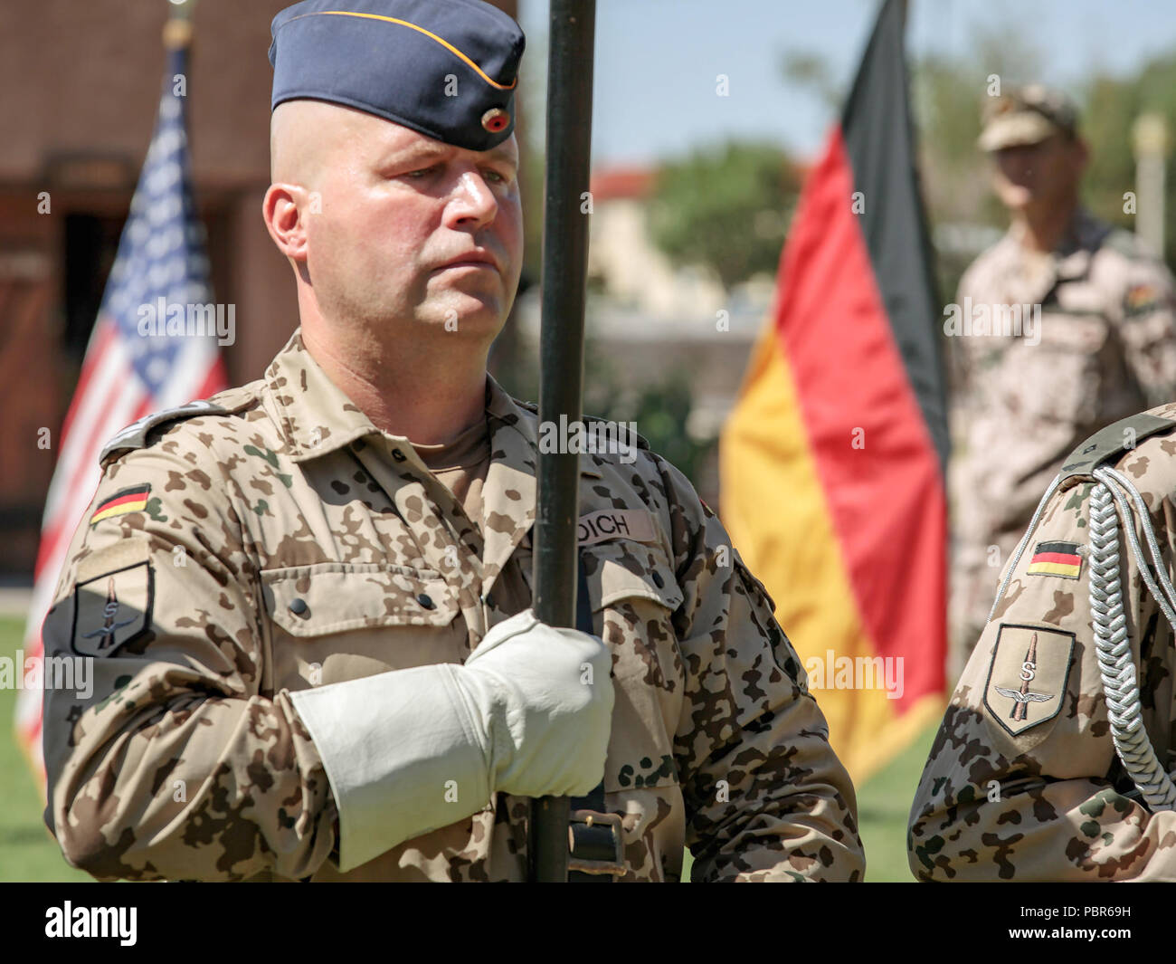 A German Air Force airman carries his unit’s colors during the German ...