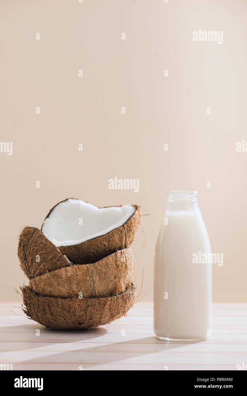 Coconut milk in bottle and glass on table with copy space Stock Photo ...