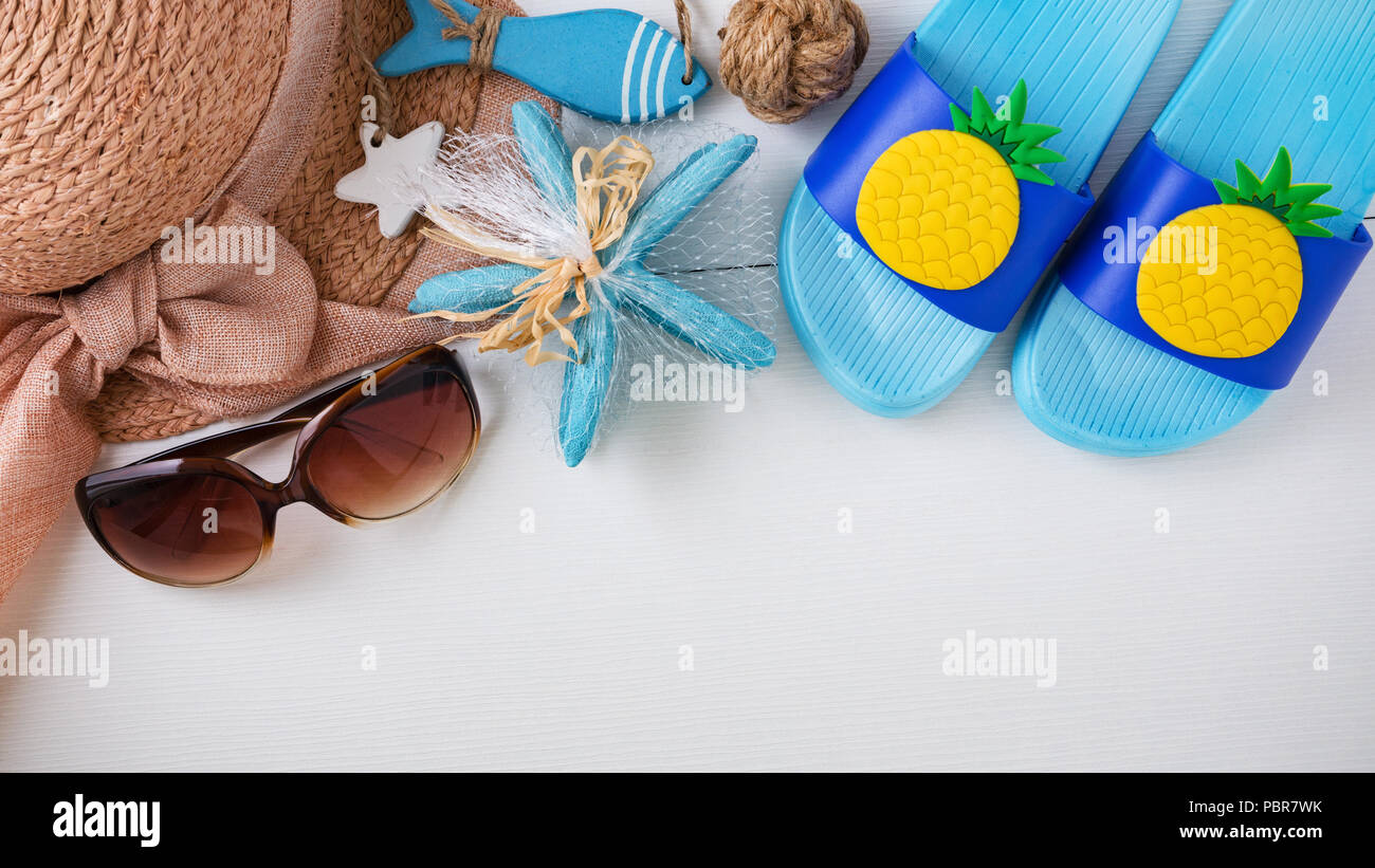 Summer beach accessories with sunglasses, hat and sandals on white ...