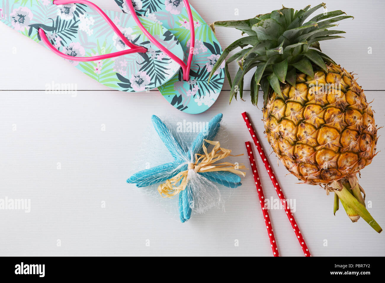 Summer beach vacation background with pineapple, flip-flops and star ...