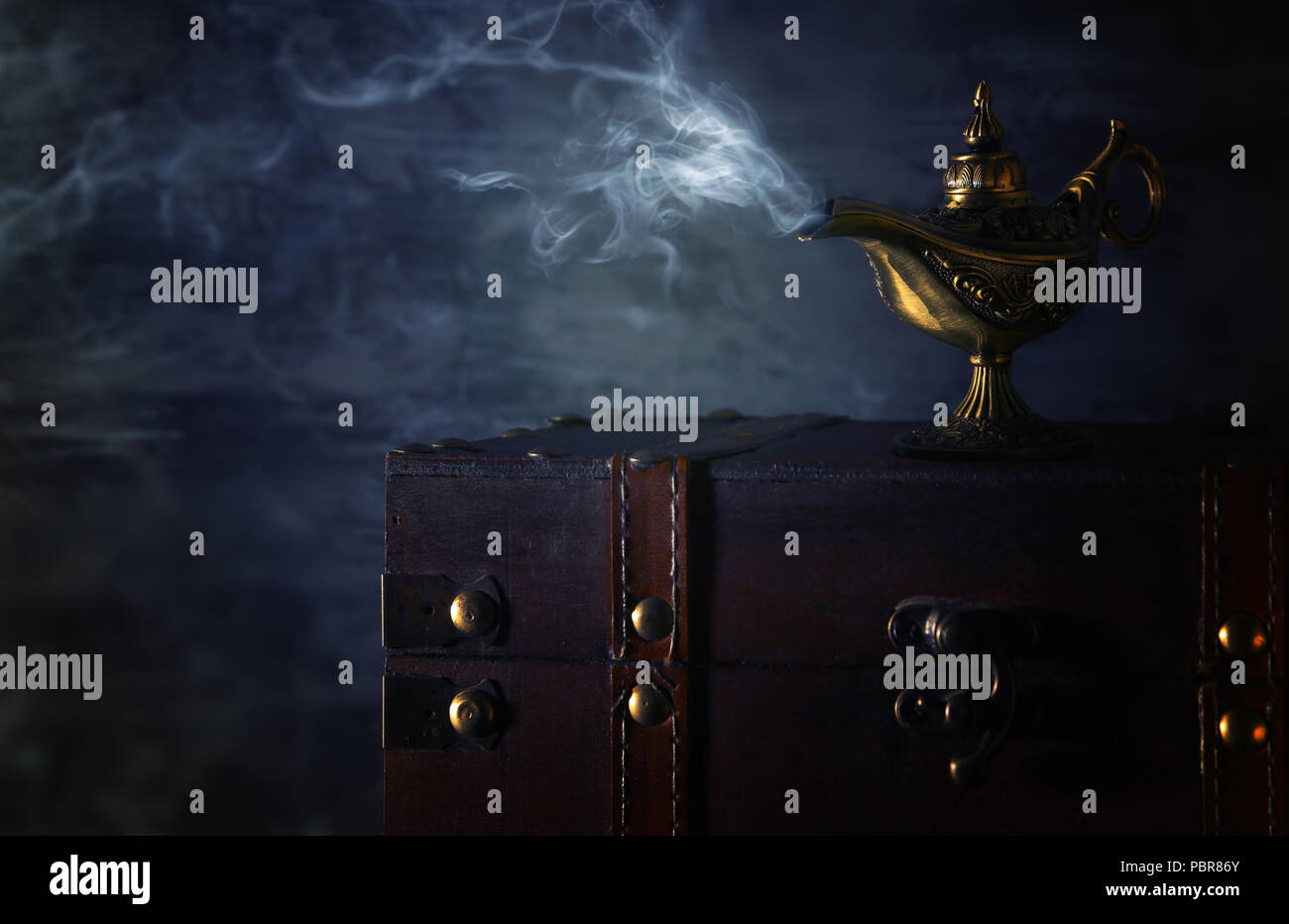 Image of magical mysterious aladdin lamp with smoke over black ...