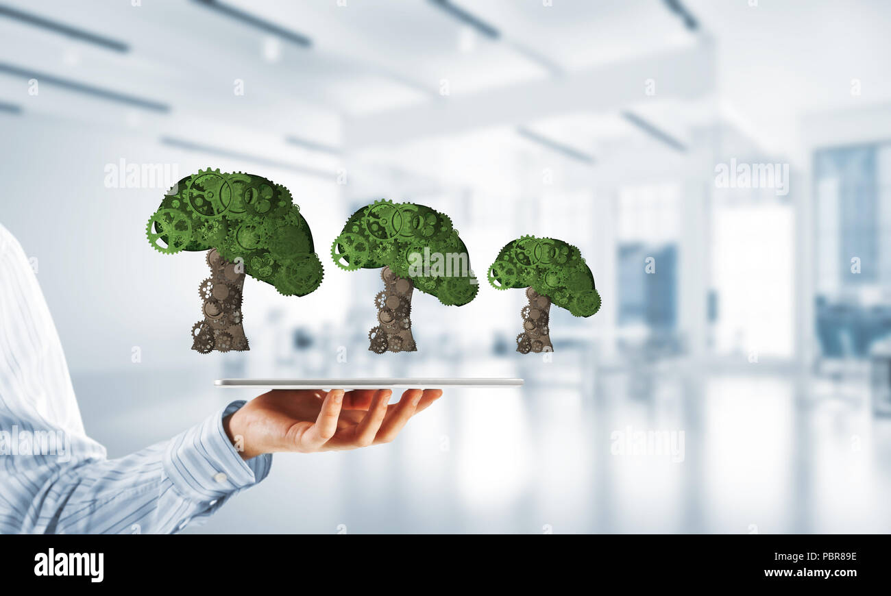 Eco green environment concept presented by tree as working mechanism or ...