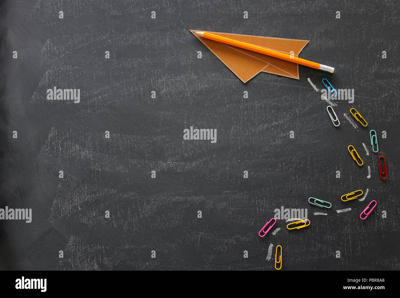 Top view image of paper plane over classroom blackboard background ...